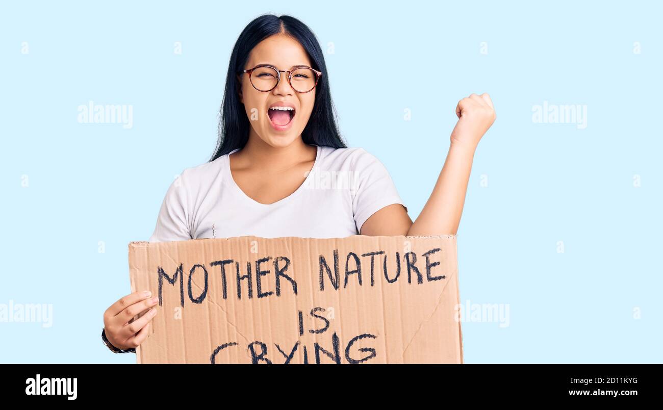 Young beautiful asian girl holding mother nature is crying protest ...