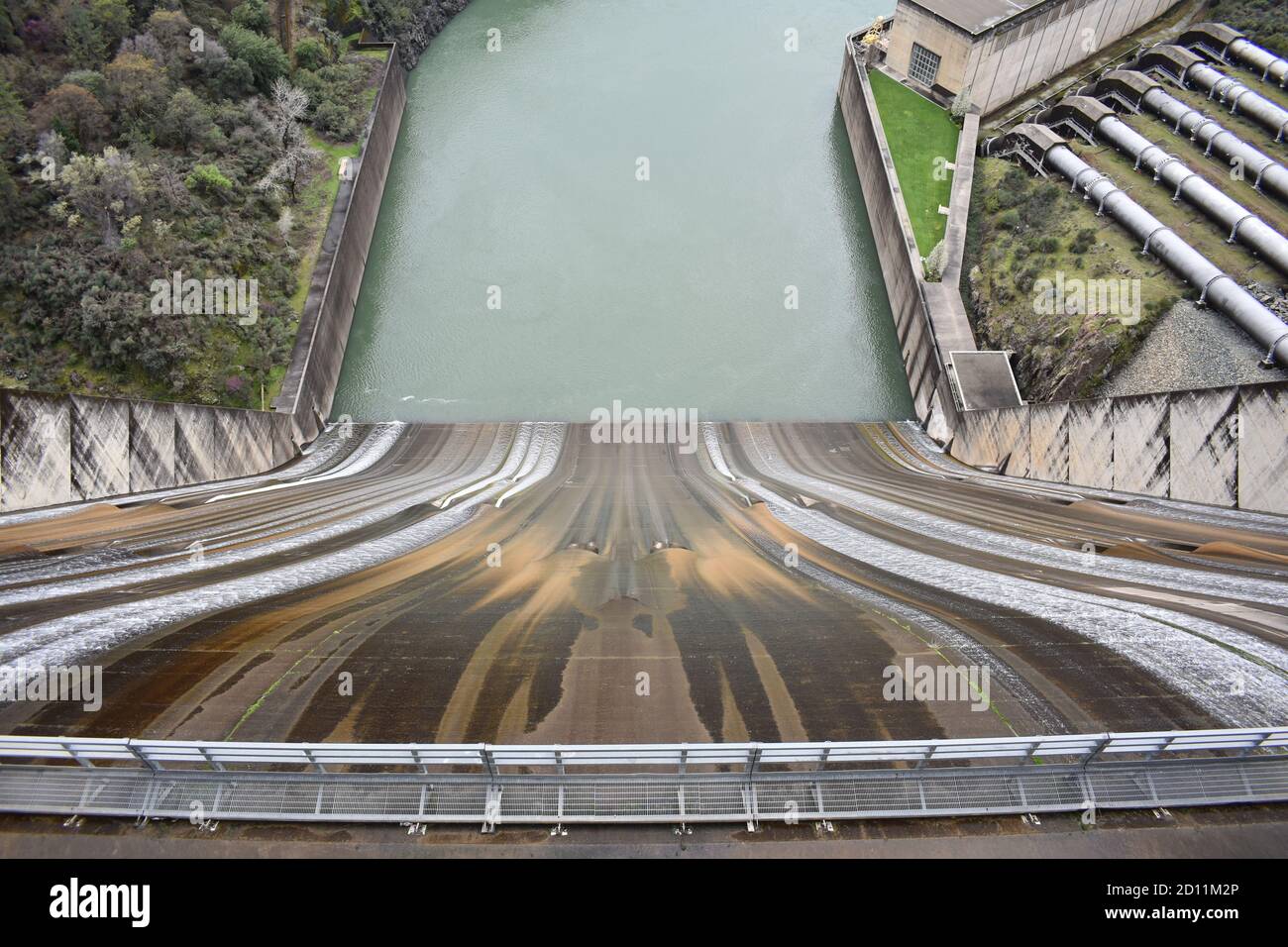 High angle shot of the concrete dam and the river in the industrial ...
