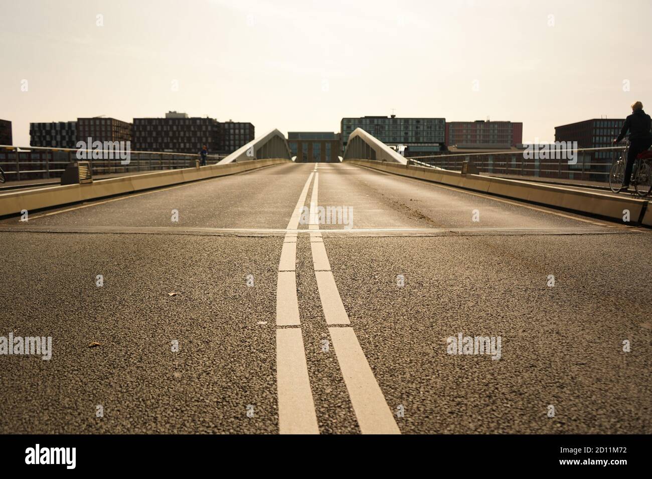 Long asphalt road on the bridge gleaming under the sunny sky Stock ...