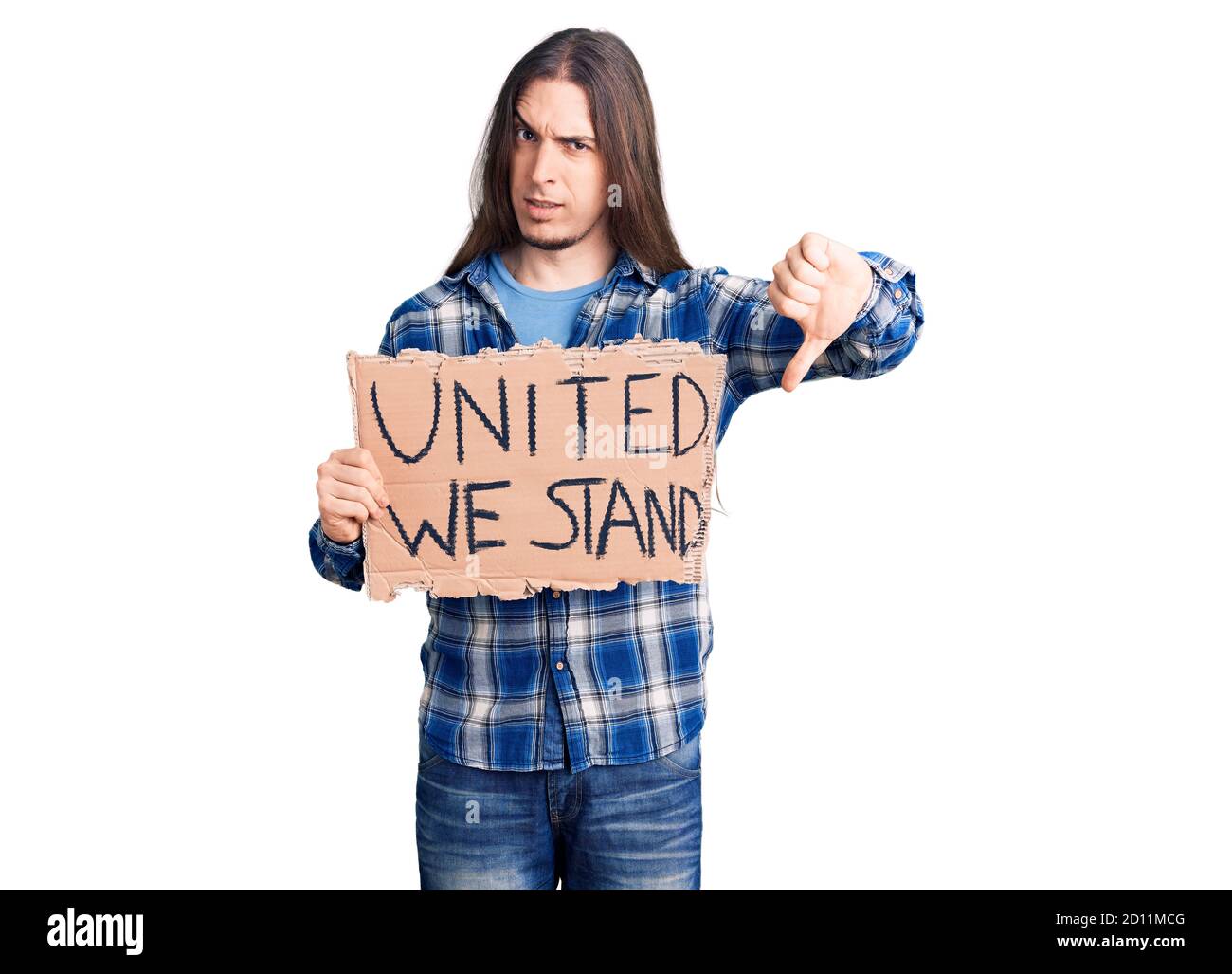 Young adult man with long hair holding united we stand banner with ...