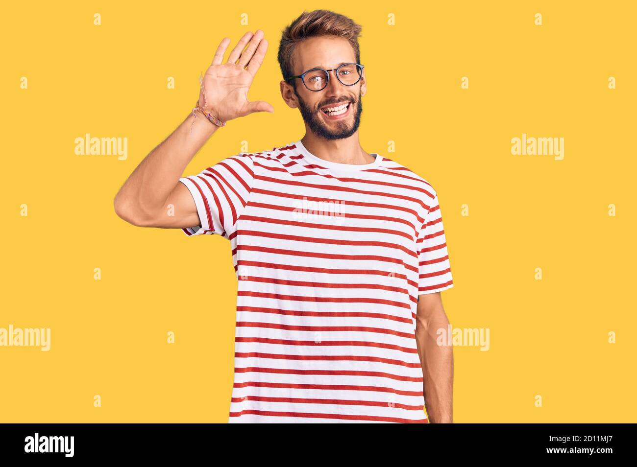 Handsome blond man with beard wearing casual clothes and glasses ...