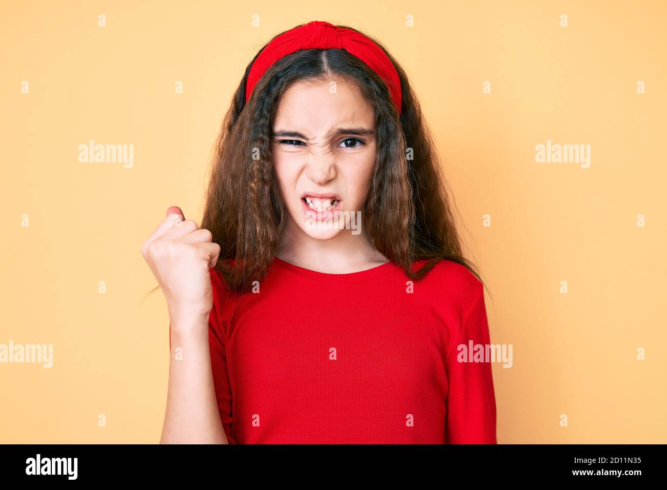 Cute hispanic child girl wearing casual clothes and diadem angry and ...