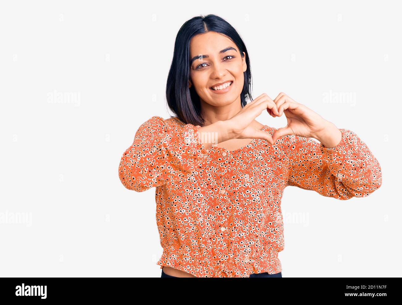 Young beautiful latin woman wearing casual clothes smiling in love ...