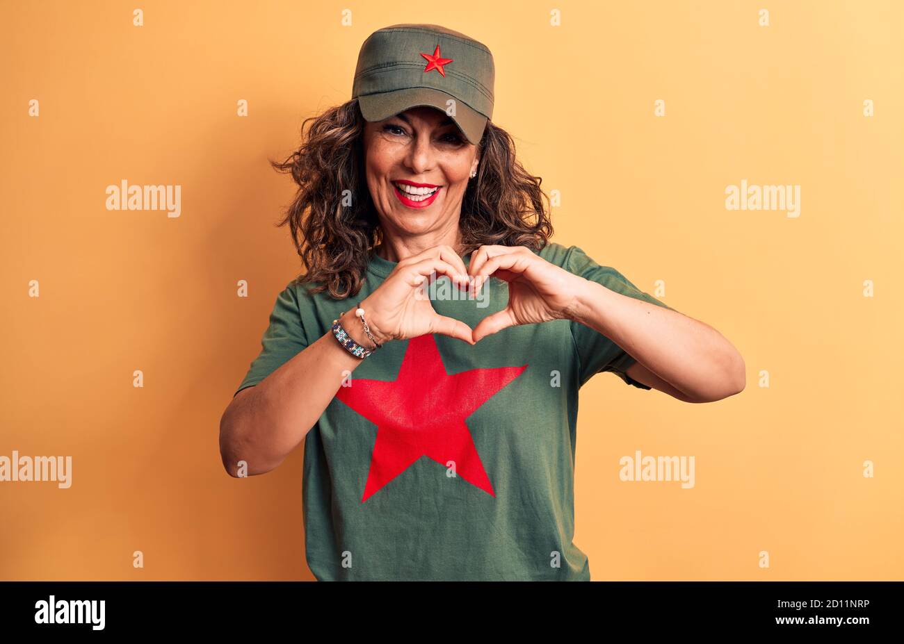 Middle age brunette woman wearing t-shirt and cap with red star symbol ...
