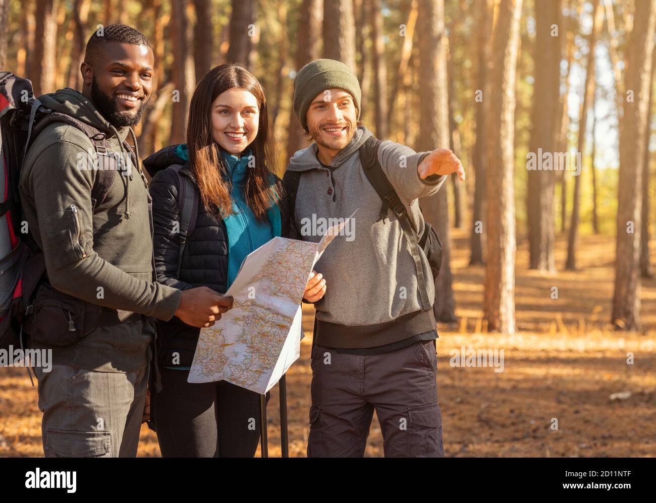 Funny backpackers looking for path, using map Stock Photo - Alamy