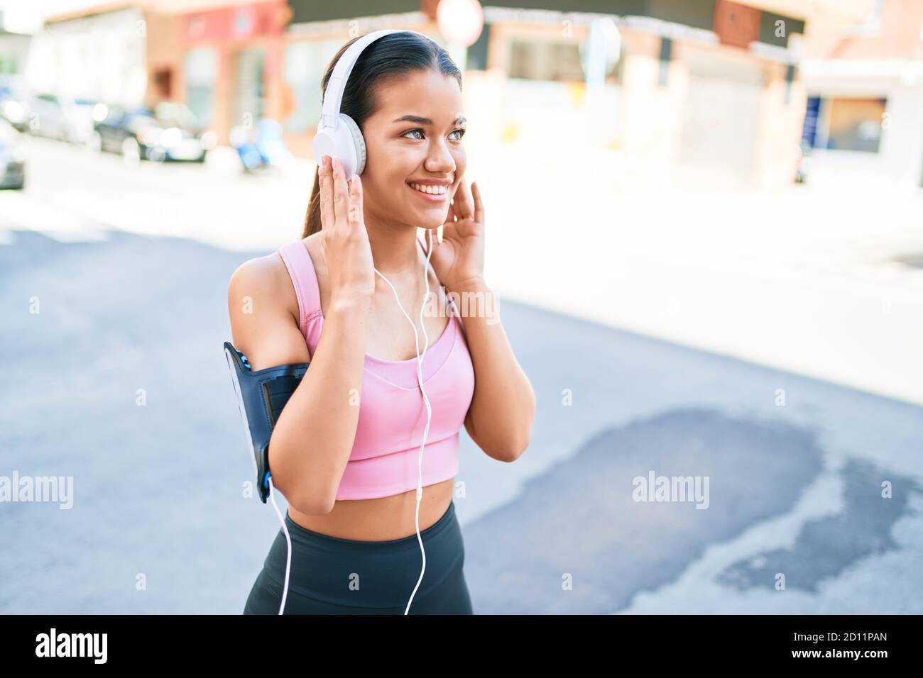 Young beautiful hispanic sport woman wearing runner outfit and ...
