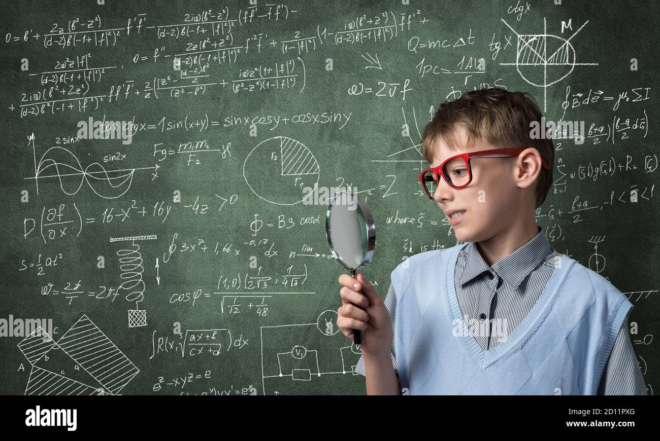 Curious school boy with magnifier Stock Photo - Alamy