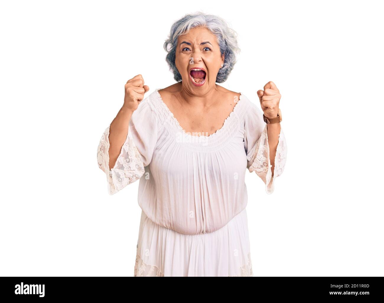 Senior woman with gray hair wearing bohemian style angry and mad ...