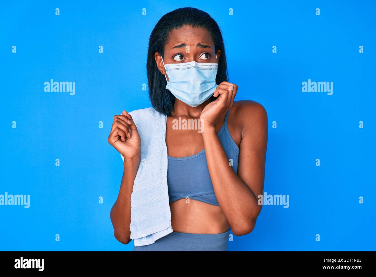 Young african american woman wearing sportswear and medical mask ...