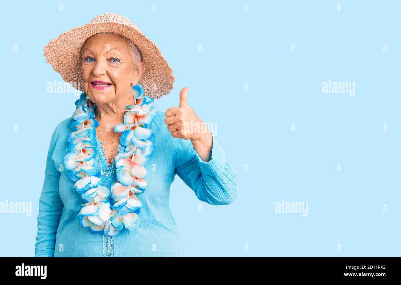 Senior beautiful woman with blue eyes and grey hair wearing summer hat ...