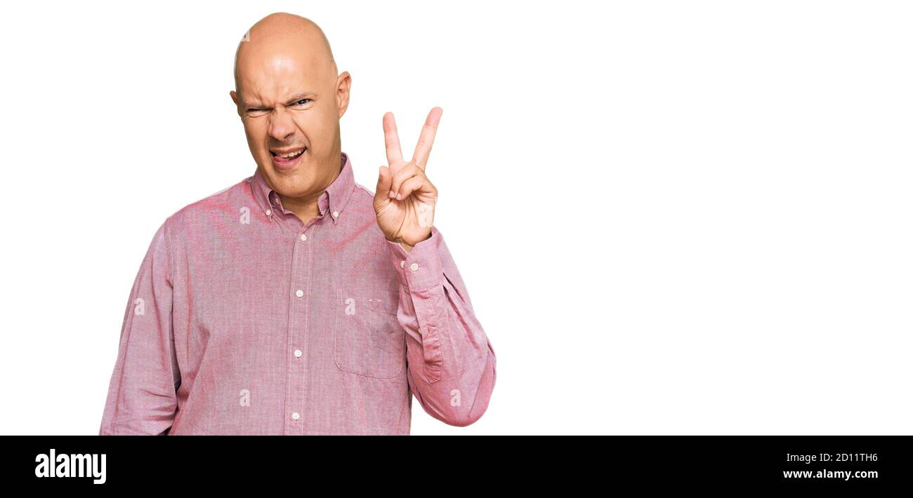 Middle age bald man wearing casual clothes smiling with happy face ...