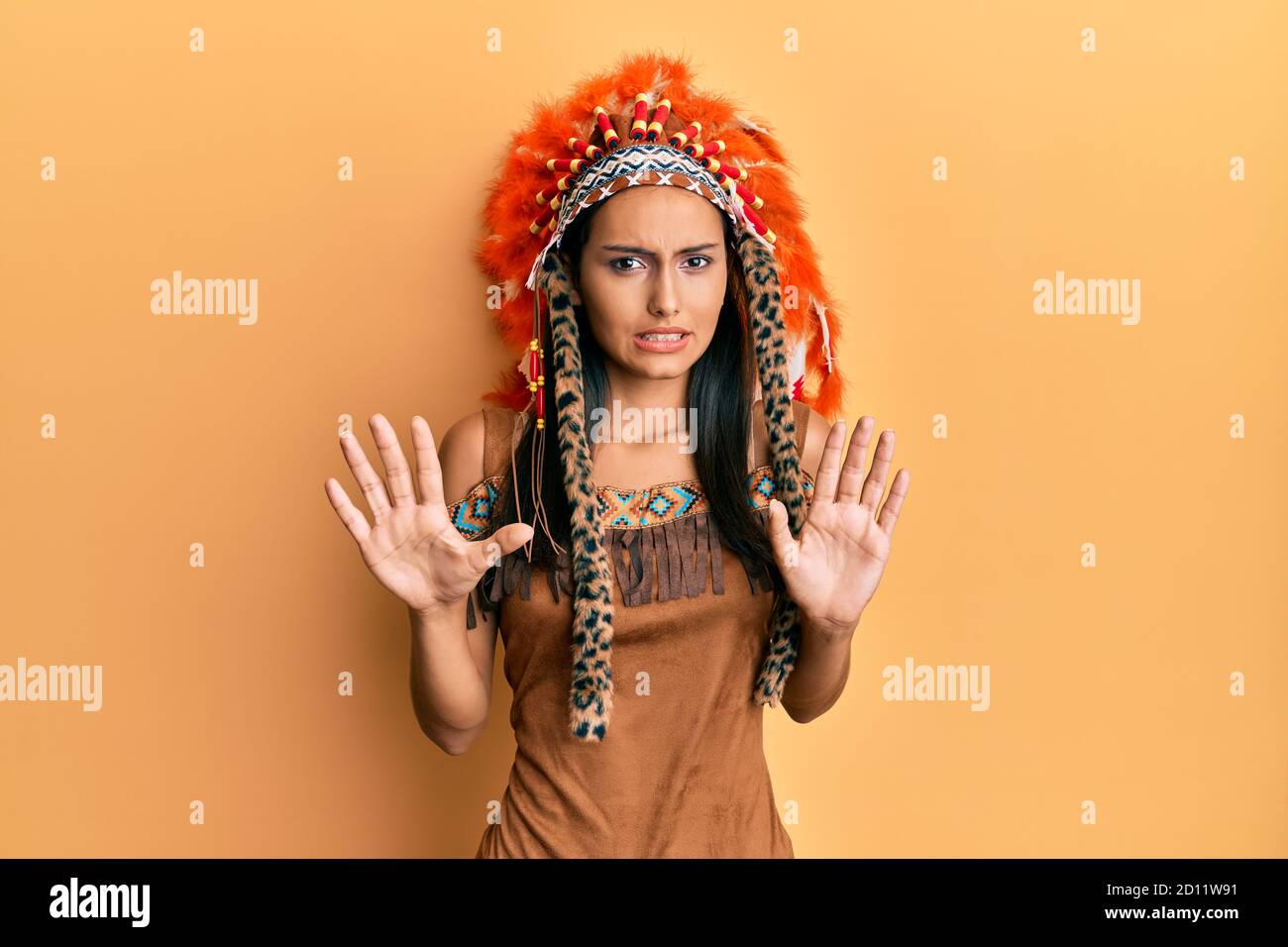 Young brunette woman wearing indian costume afraid and terrified with ...