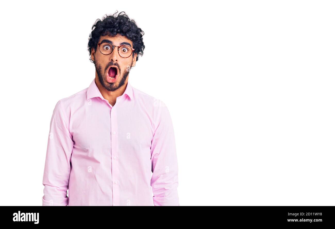 Handsome young man with curly hair and bear wearing business clothes ...