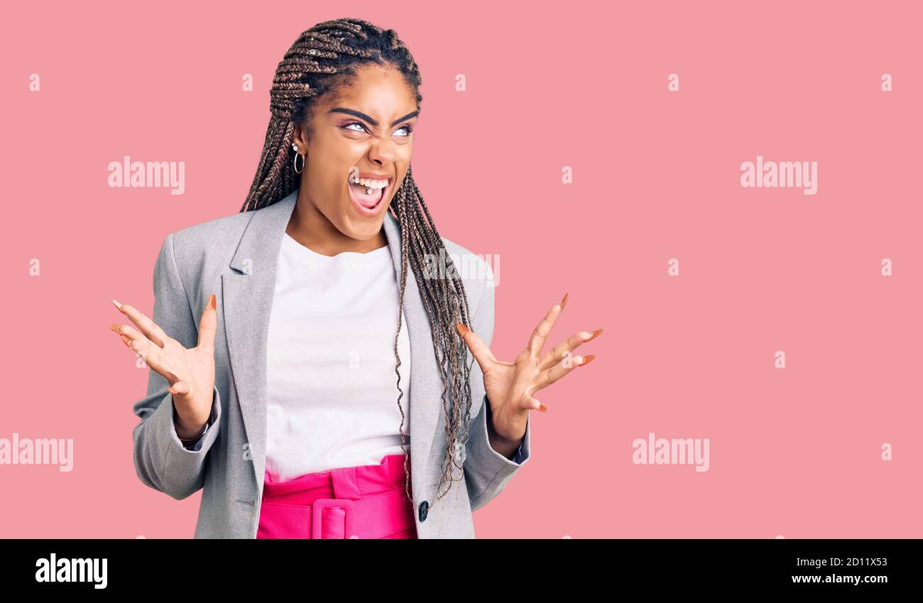 Young african american woman with braids wearing business clothes crazy ...