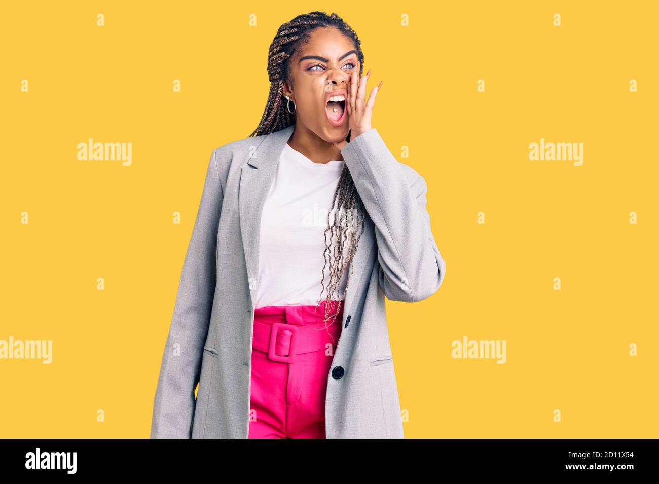 Young african american woman with braids wearing business clothes ...