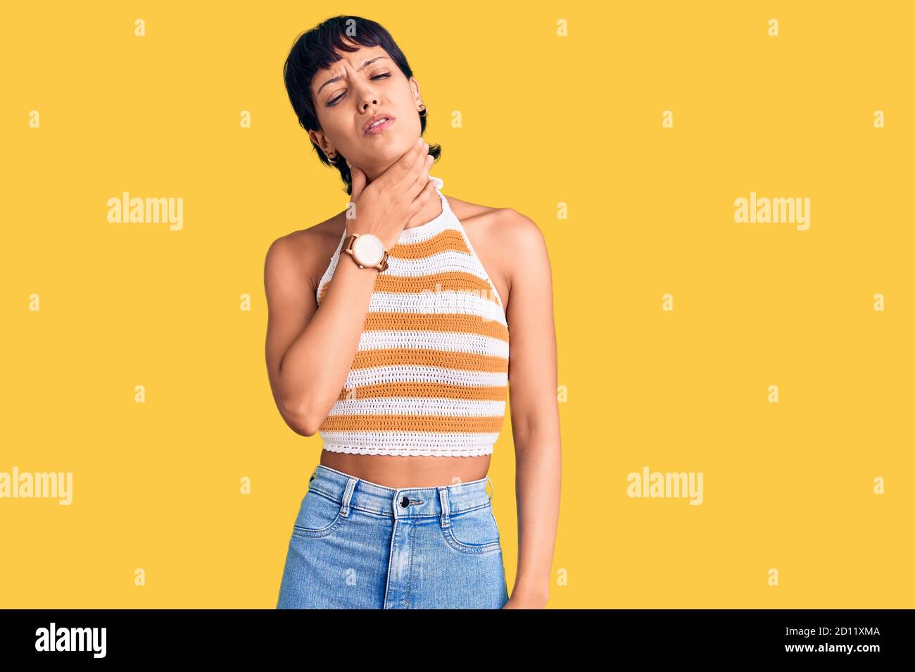 Young brunette woman with short hair wearing casual clothes touching ...