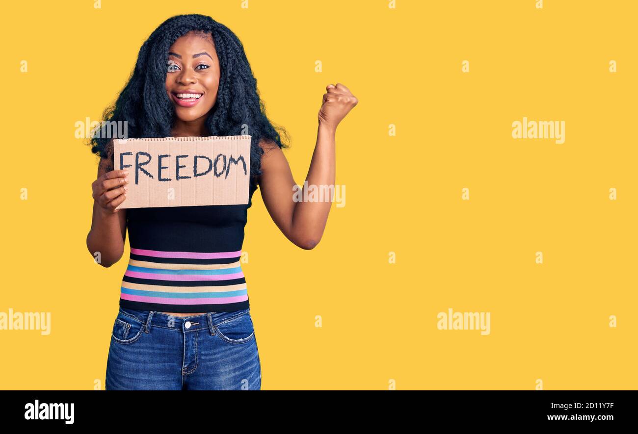 Beautiful african american woman holding freedom banner screaming proud ...