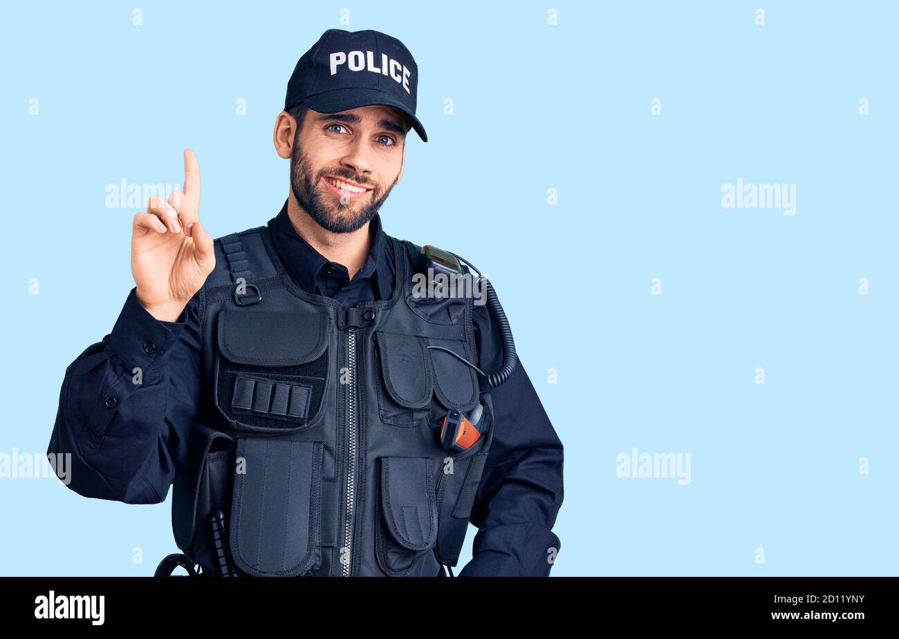 Young handsome man with beard wearing police uniform showing and ...