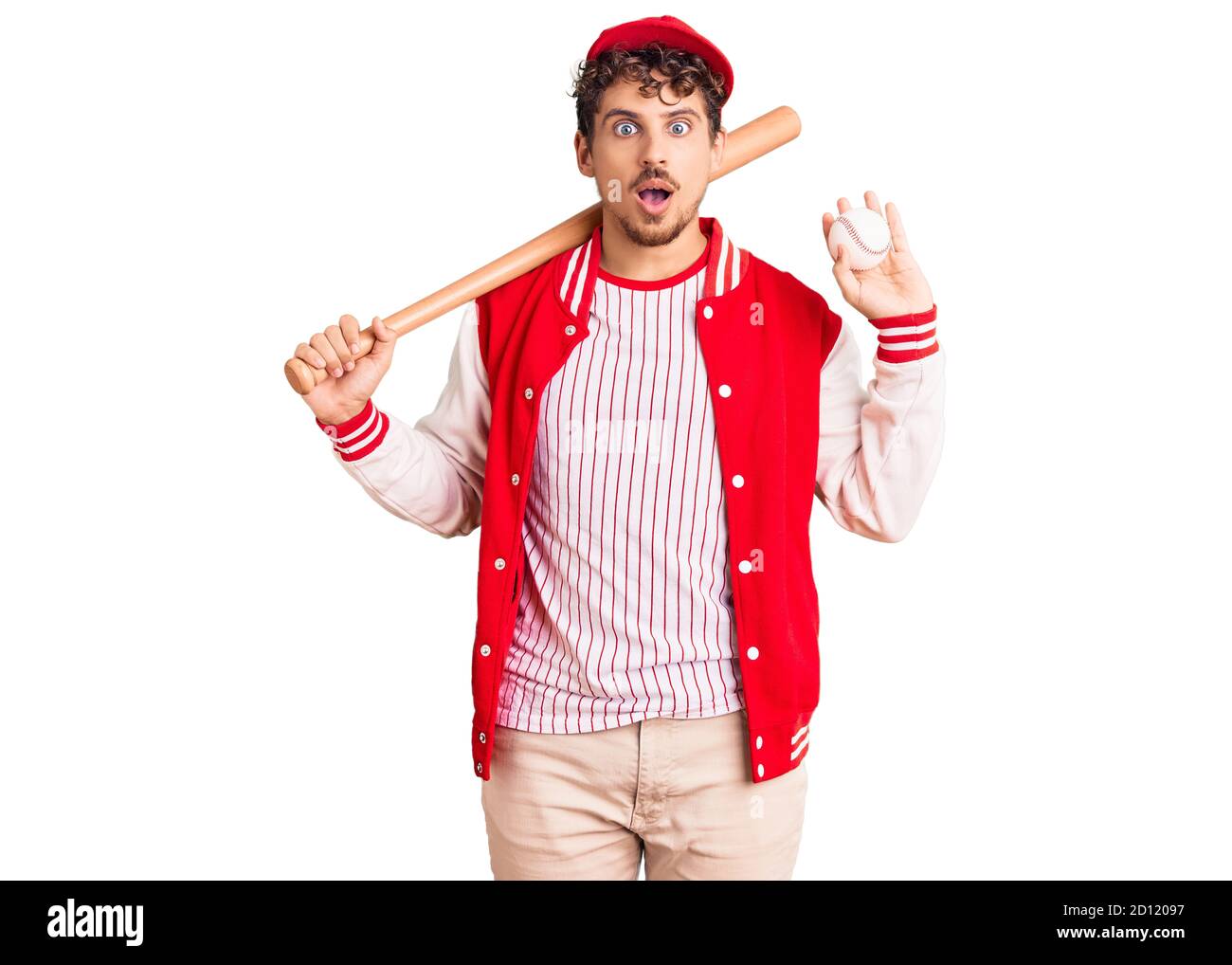 Young handsome man with curly hair playing baseball holding bat and ...