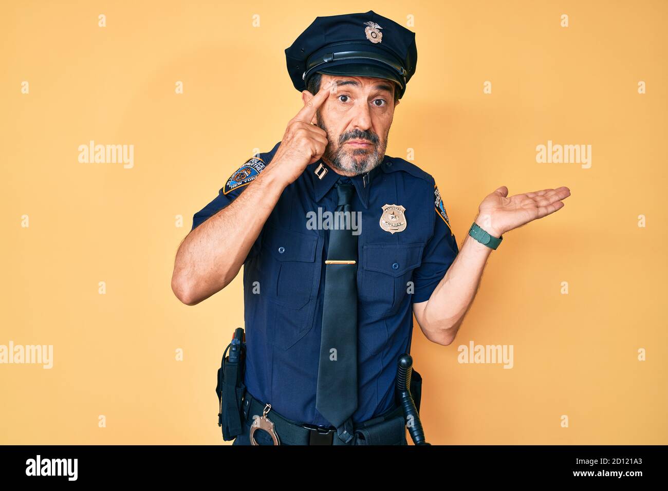 Middle age hispanic man wearing police uniform confused and annoyed ...