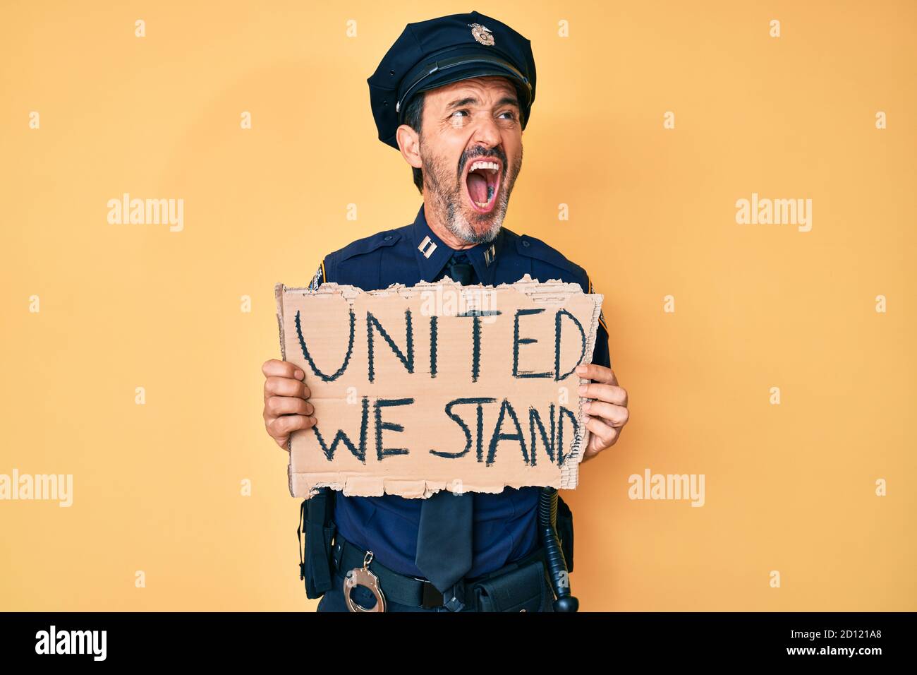 Middle age hispanic man wearing police uniform holding united we stand ...