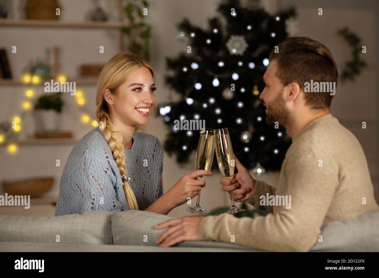 Young couple cheering with glasses of champagne Stock Photo - Alamy