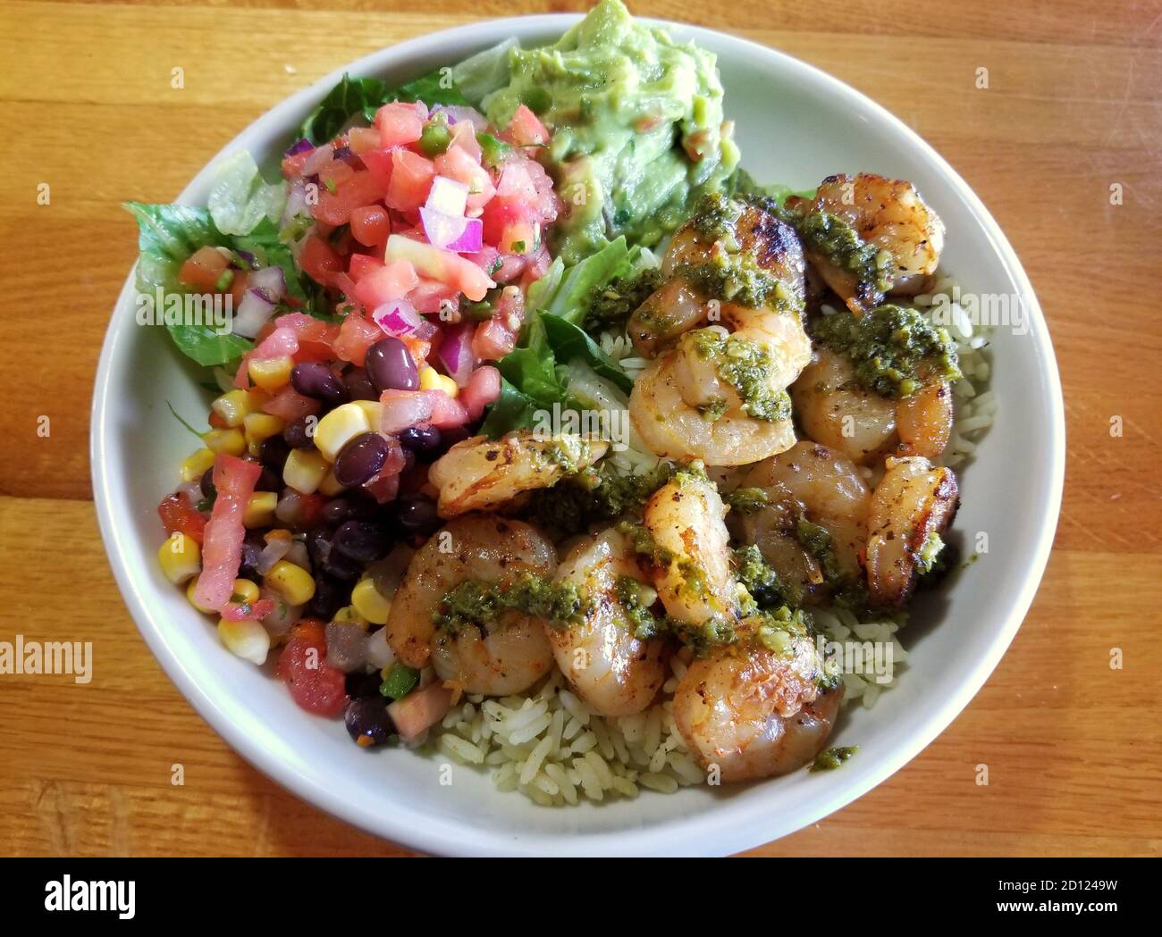 Tex-Mex shrimp salad inside a bowl with guacamole, salsa and tortilla ...