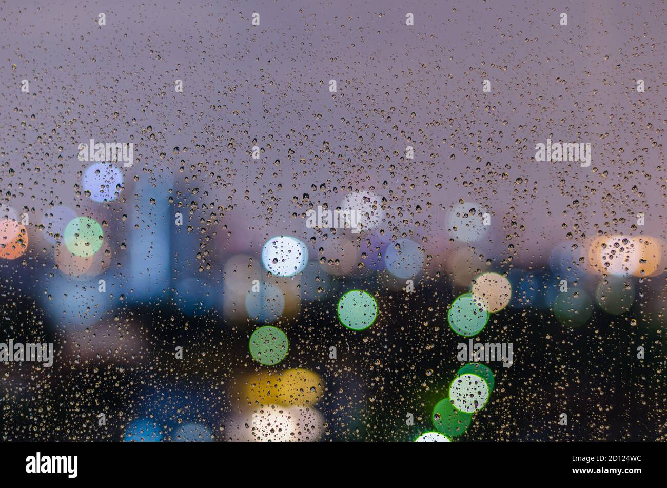 Rain drop on window with colorful bokeh lights Stock Photo - Alamy