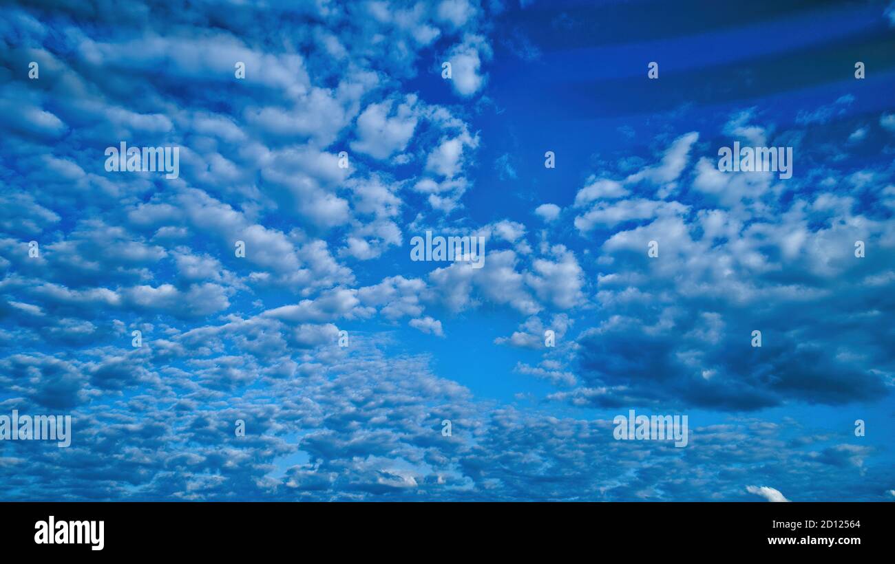 Blue sky and multiple clouds background Stock Photo - Alamy