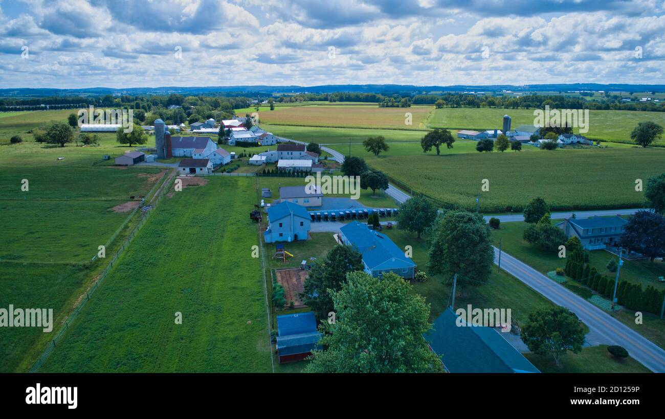 Aerial view of green farmlands and rolling crops growing on a beautiful ...