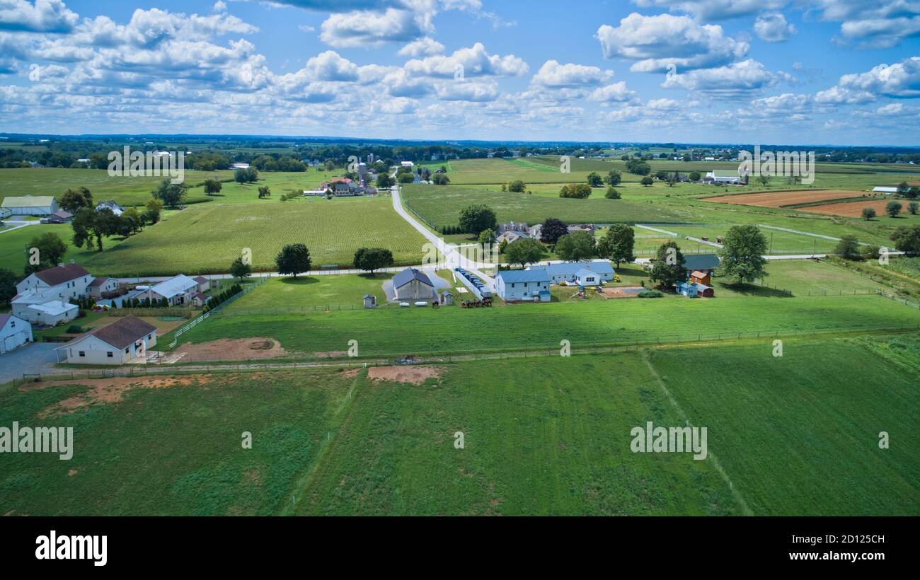 Aerial view of Amish countryside with barns and silos and a one room ...