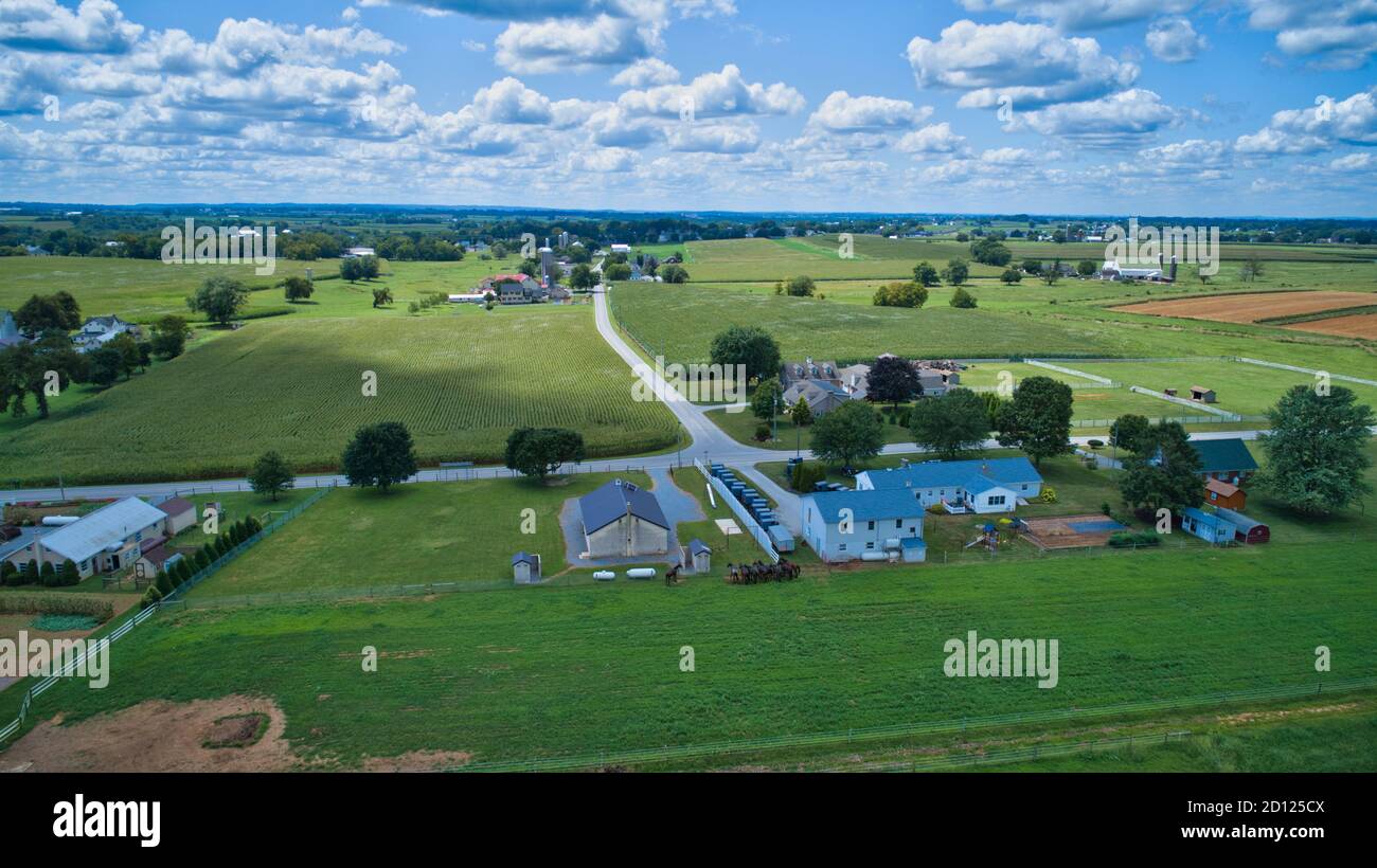 Aerial view of Amish countryside with barns and silos and a one room ...