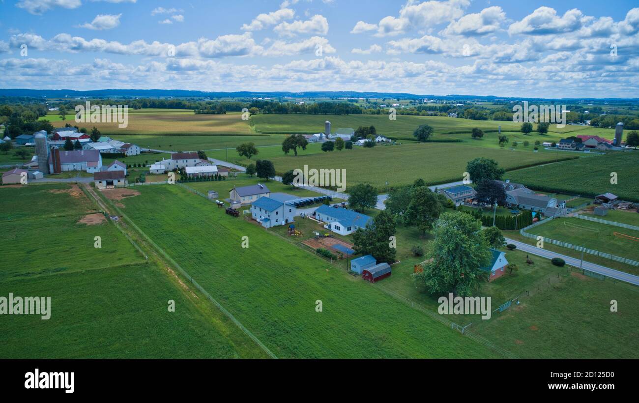 Aerial view of Amish countryside with barns and silos and a one room ...