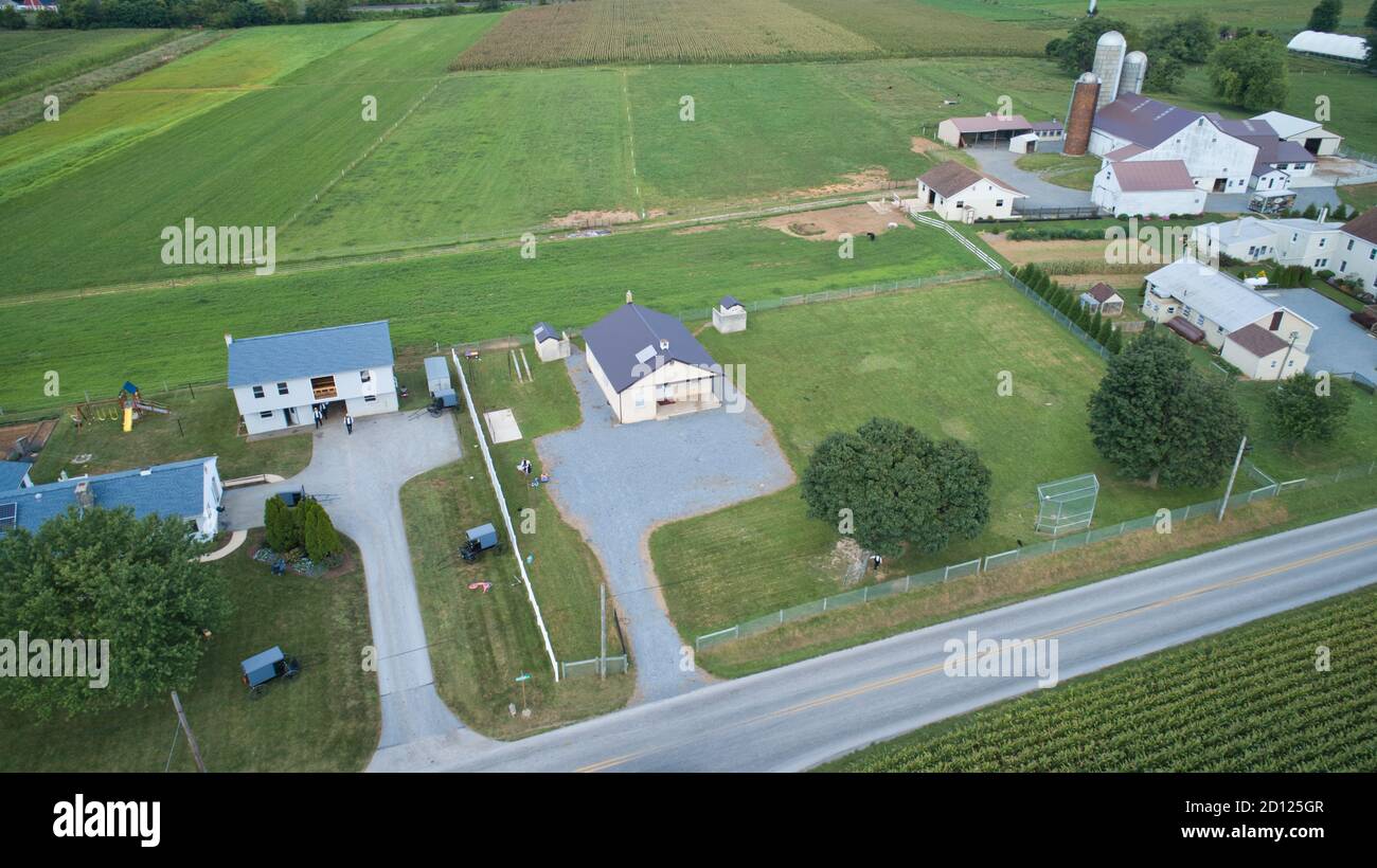 Aerial view of Amish countryside with barns and silos and a one room ...