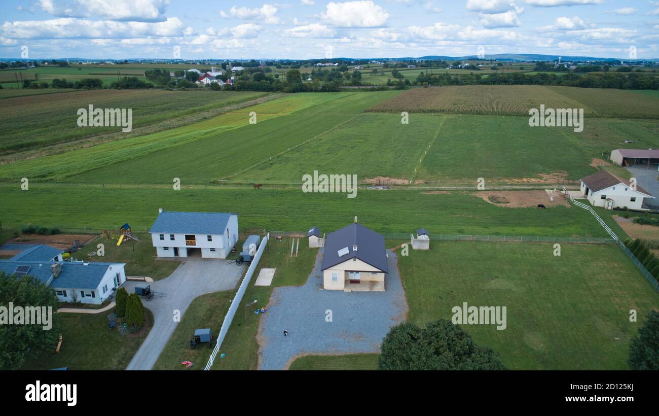 Aerial view of Amish countryside with barns and silos and a one room ...