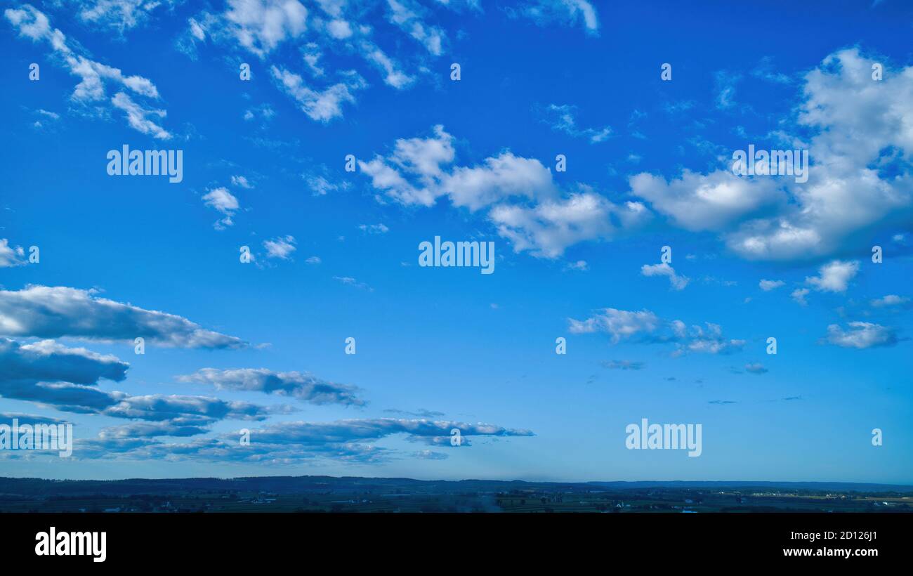 Blue sky and multiple clouds background Stock Photo - Alamy