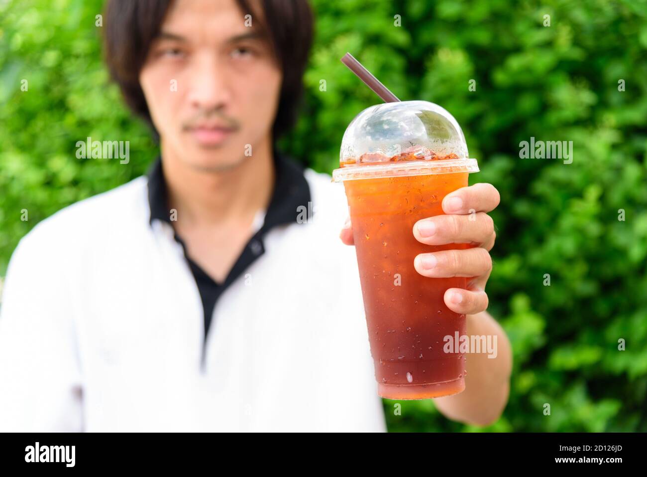 The man hand ice tea for you Stock Photo - Alamy
