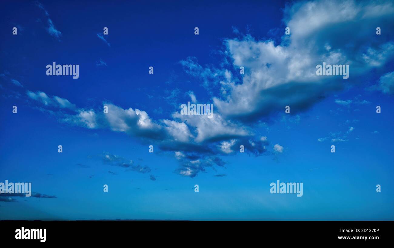Blue sky and multiple clouds background Stock Photo - Alamy