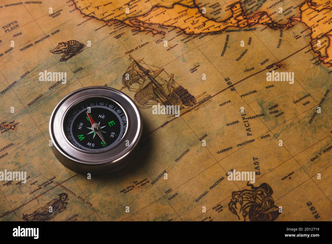Old compass discovery on vintage paper antique world map background ...
