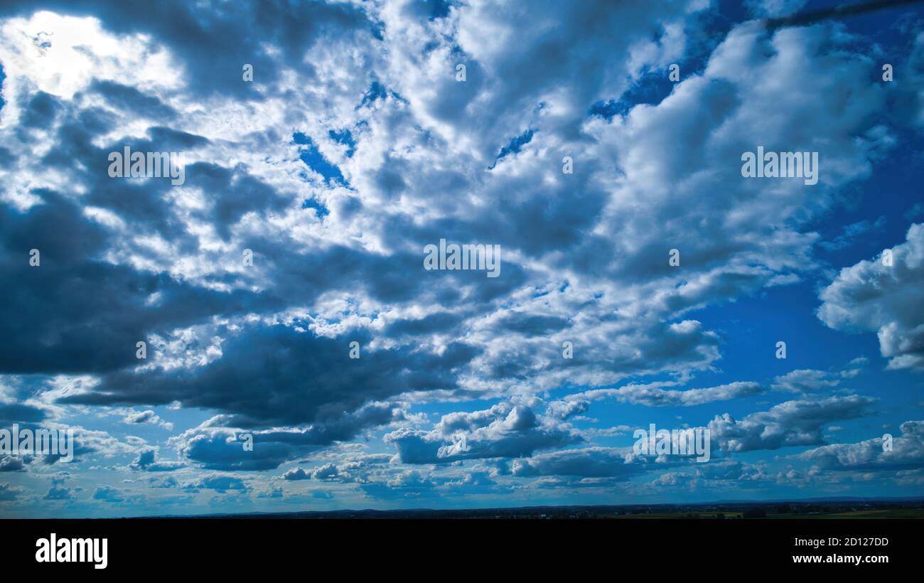 Blue sky and multiple clouds background Stock Photo - Alamy