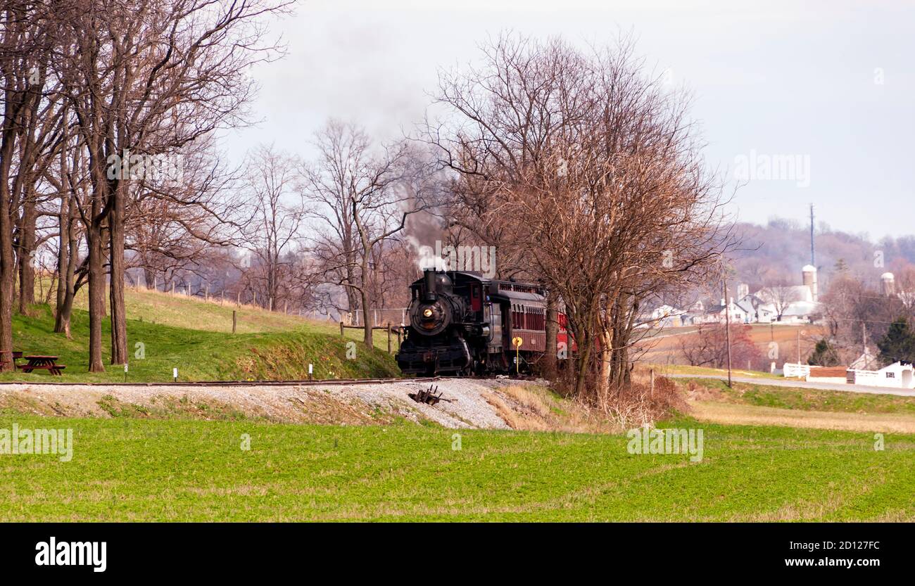 Steam train pulling passenger cars on a winter day Stock Photo - Alamy