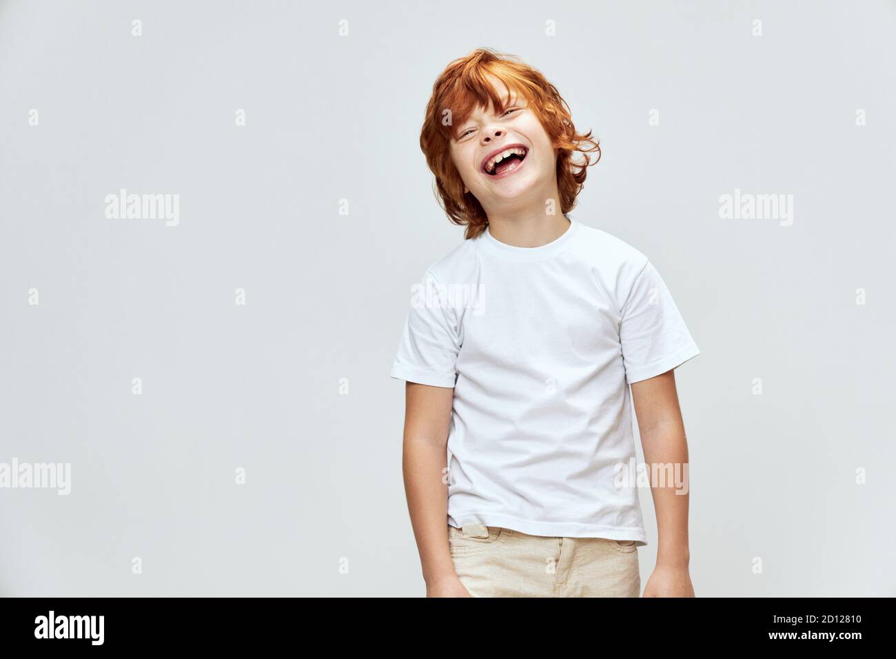 Cheerful boy laughing with mouth wide open white t-shirt cropped Stock ...