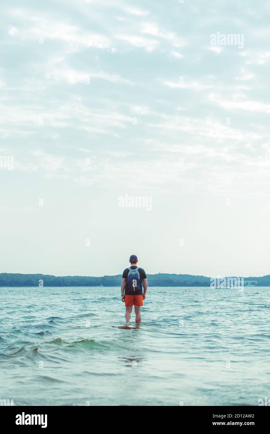 man standing in the sea water at beach Stock Photo - Alamy