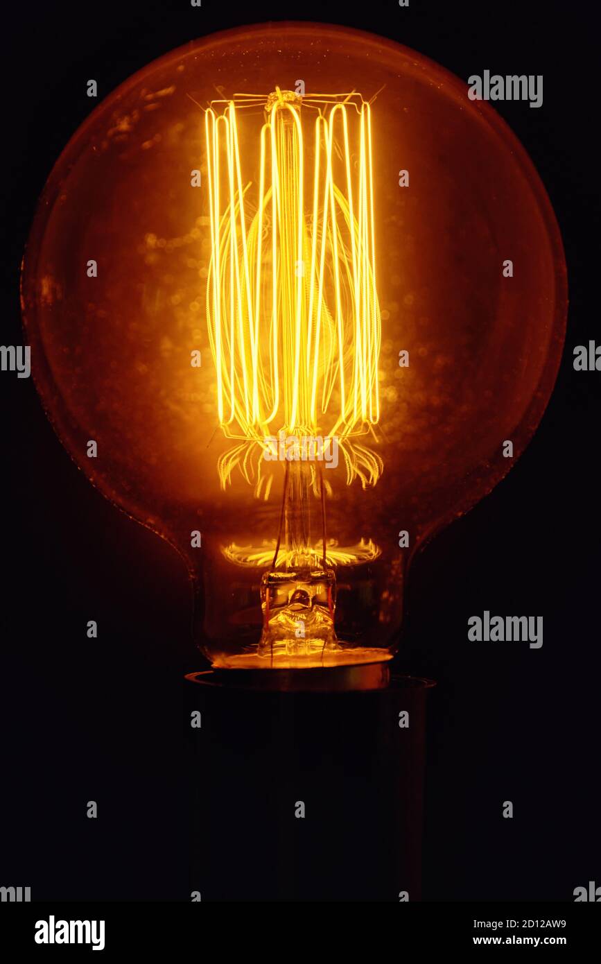 Vintage light bulb on black background, close up Glowing edison bulb ...