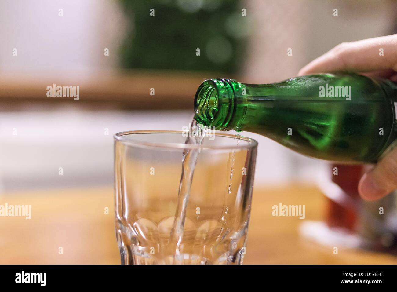 Women pouring mineral water into the glass in the restaurant Stock Photo - Alamy