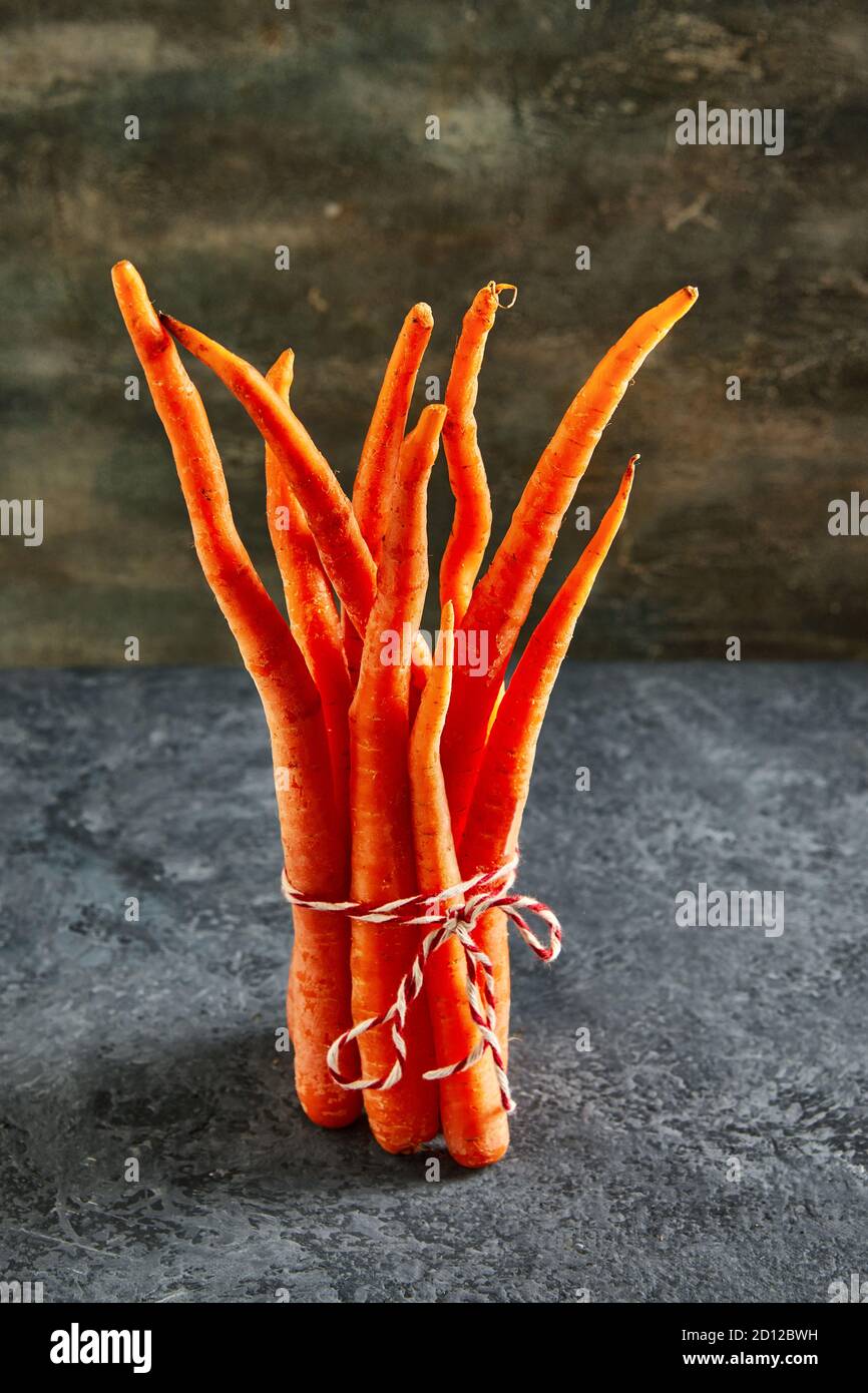 Ugly food. Deformed organic carrots on a blue background. Deformed ...