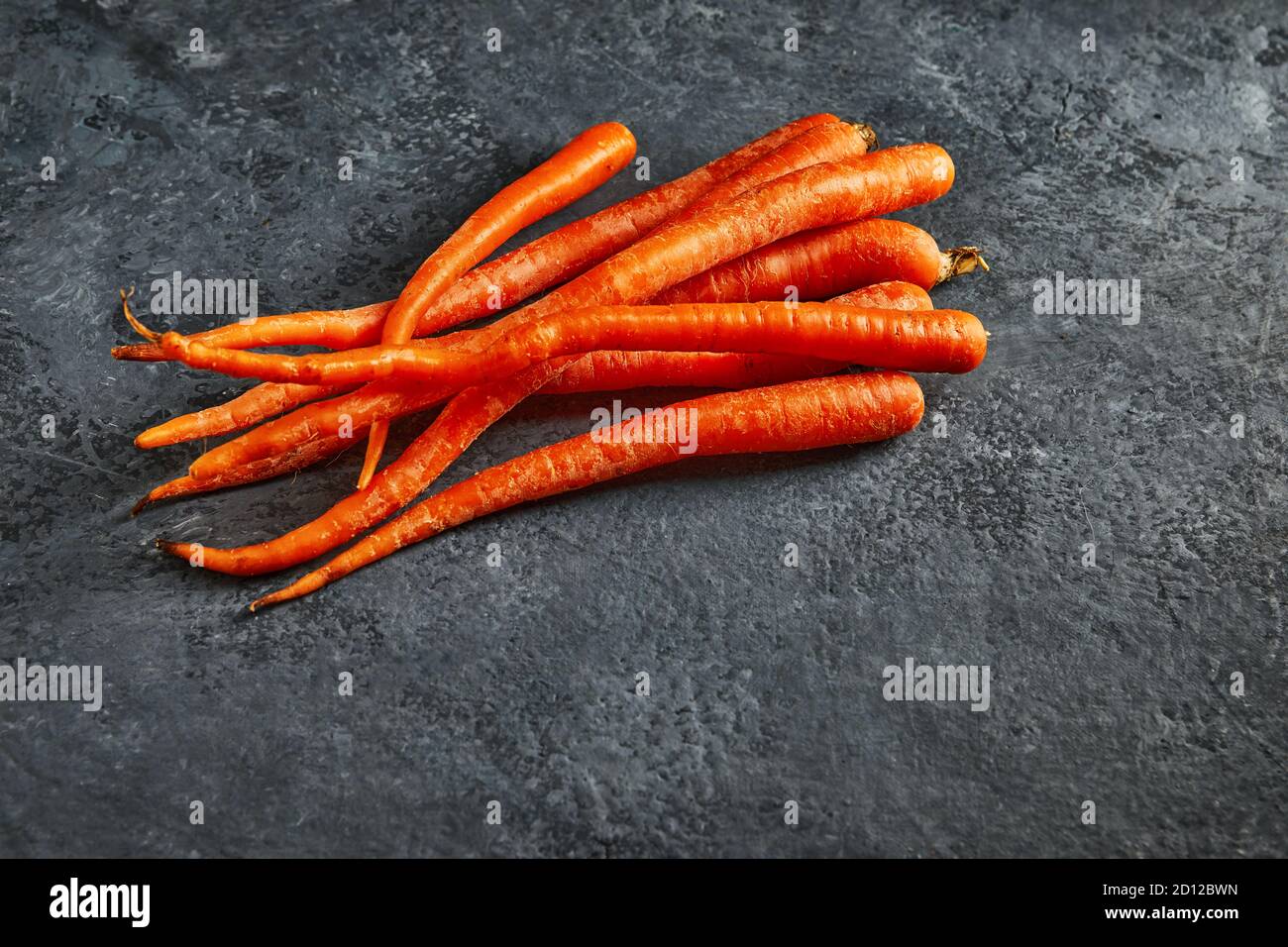 Ugly food. Deformed organic carrots on a blue background. Deformed ...