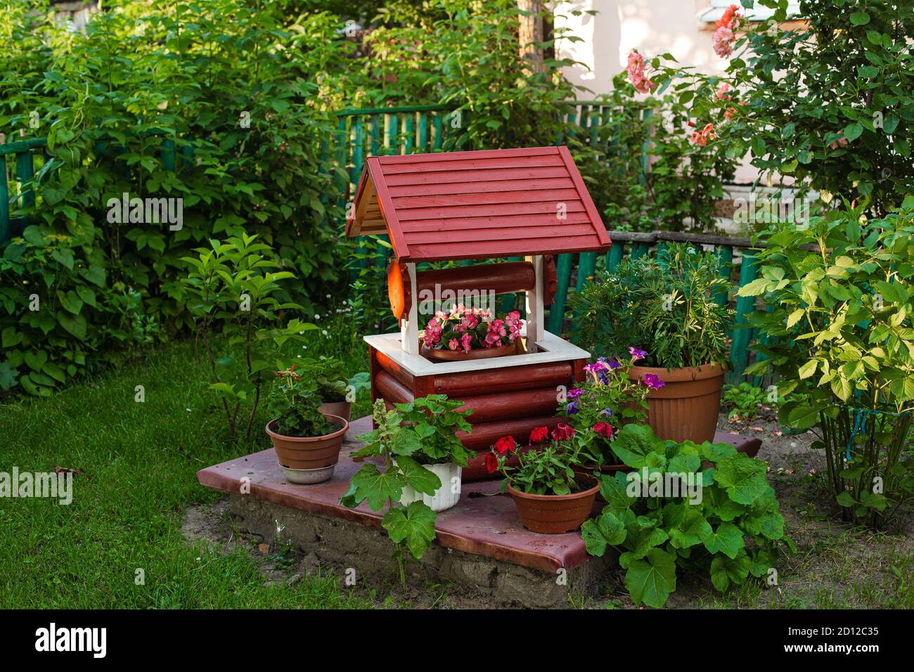 A small decorative well with a lot of color near it in the village yard ...