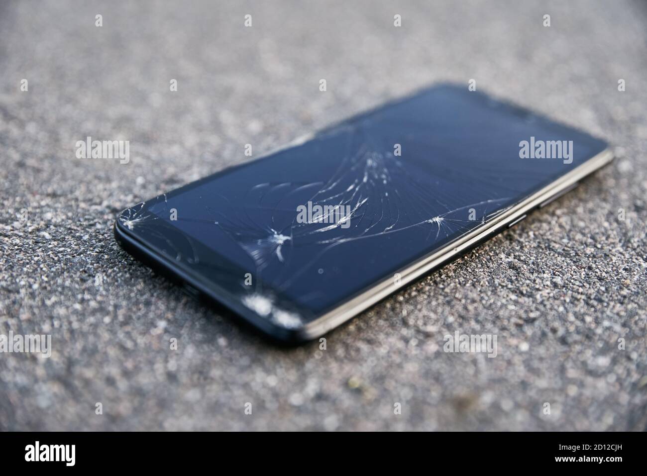 Damaged smartphone with broken touch screen on the asphalt Stock Photo ...