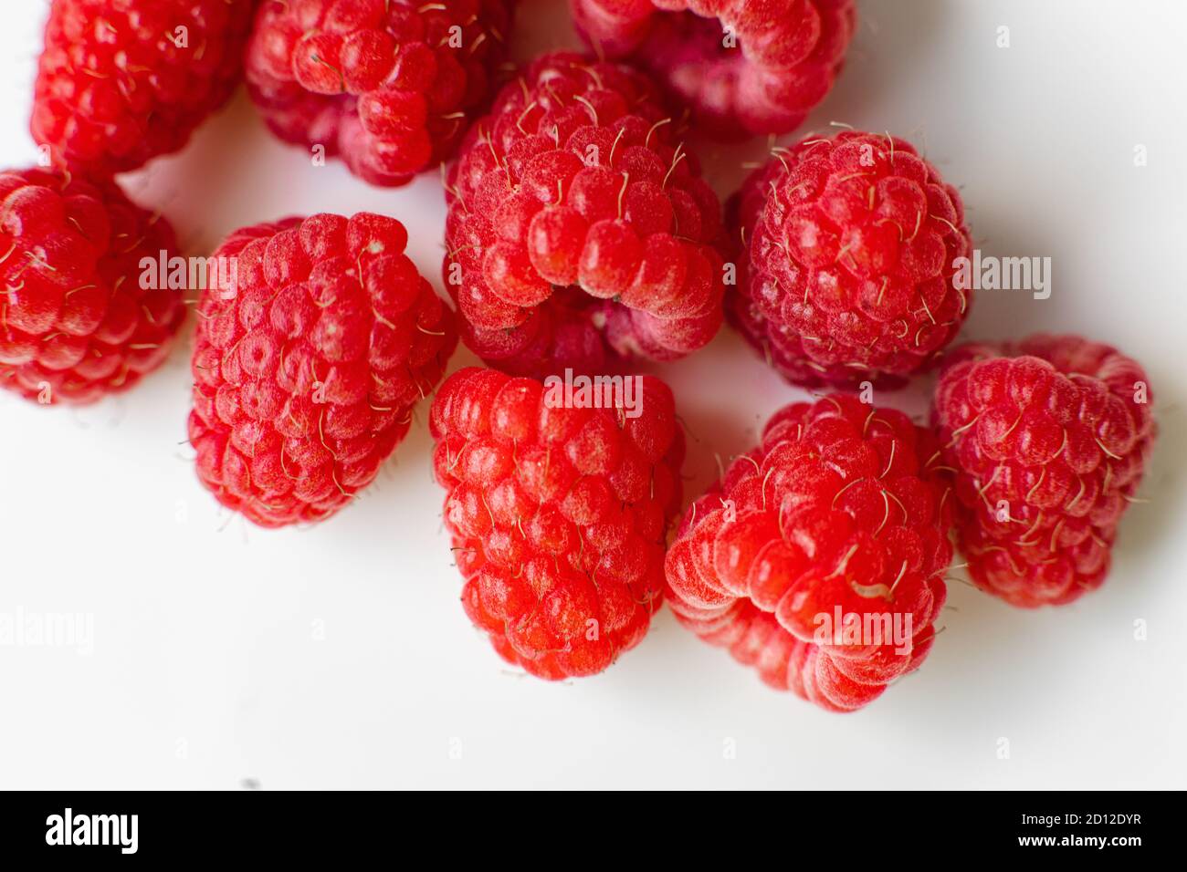 Beautiful raspberries in triangle shape lies isolated on a white ...